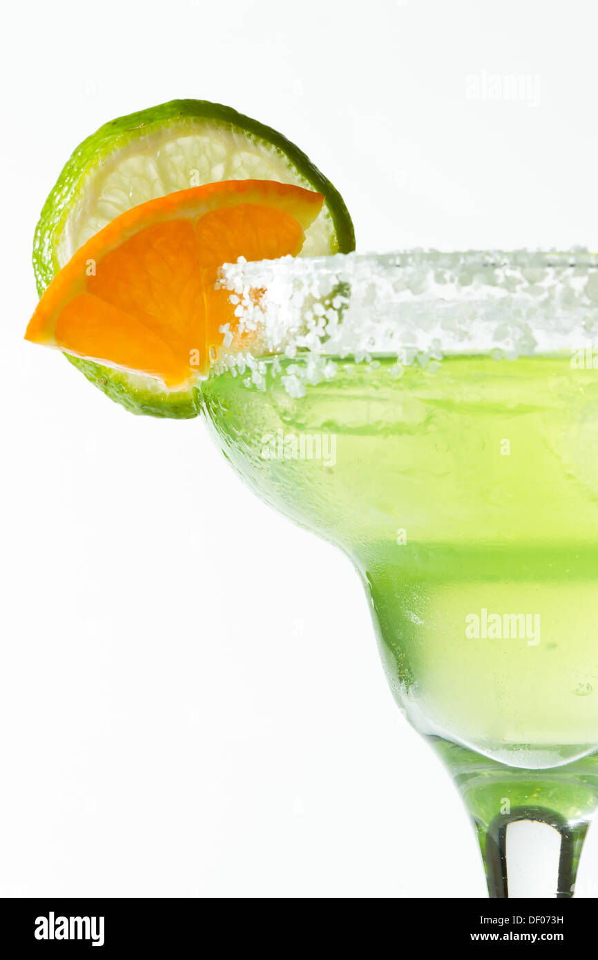 classic margarita with a salt rim, lime and orange garnish isolated on ...