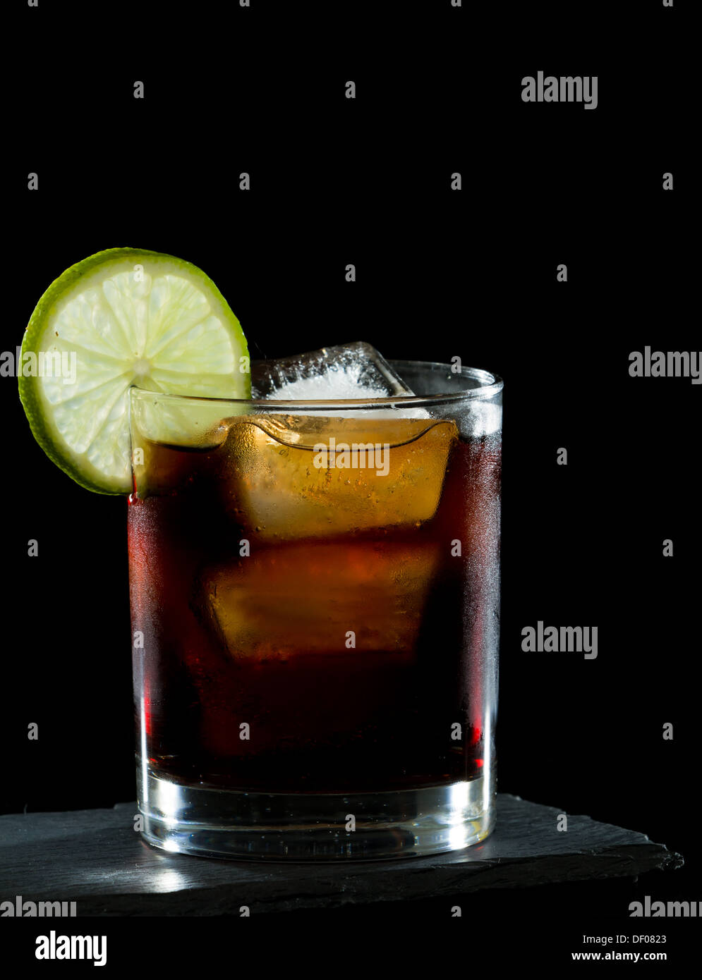 classic cocktail served on the rocks isolated on a black background ...
