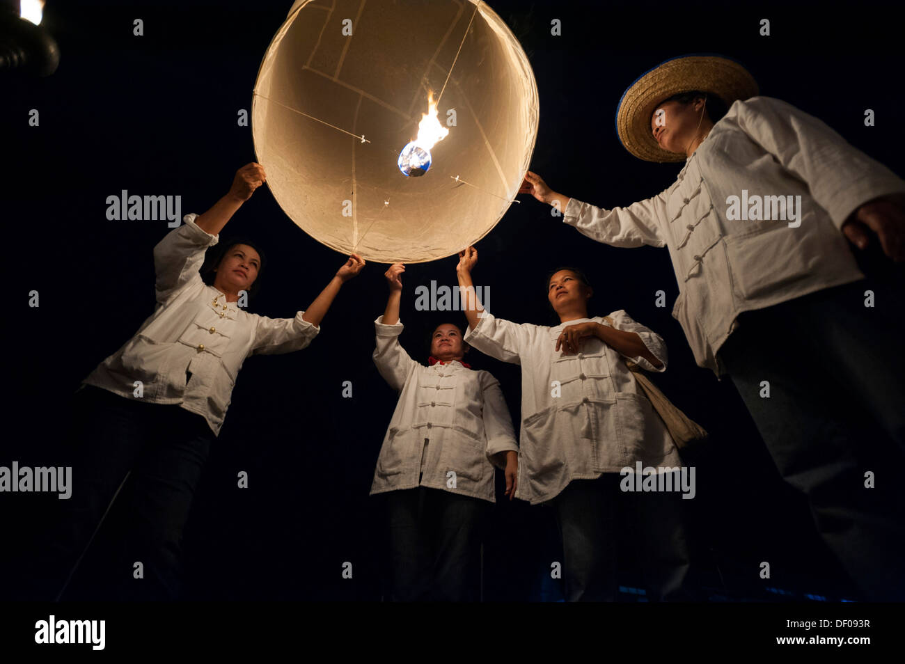 People releasing a Kongming lantern or sky lantern for luck during the ...