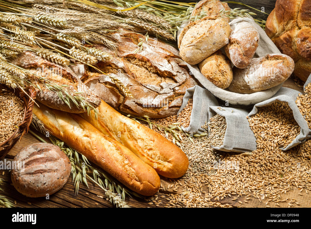 Whole wheat bread on old wooden table Stock Photo - Alamy