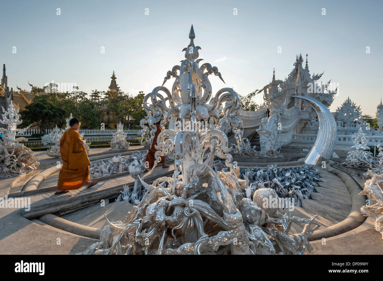 Buddhist monk walking across a bridge, sculptures depicting hell, Wat ...