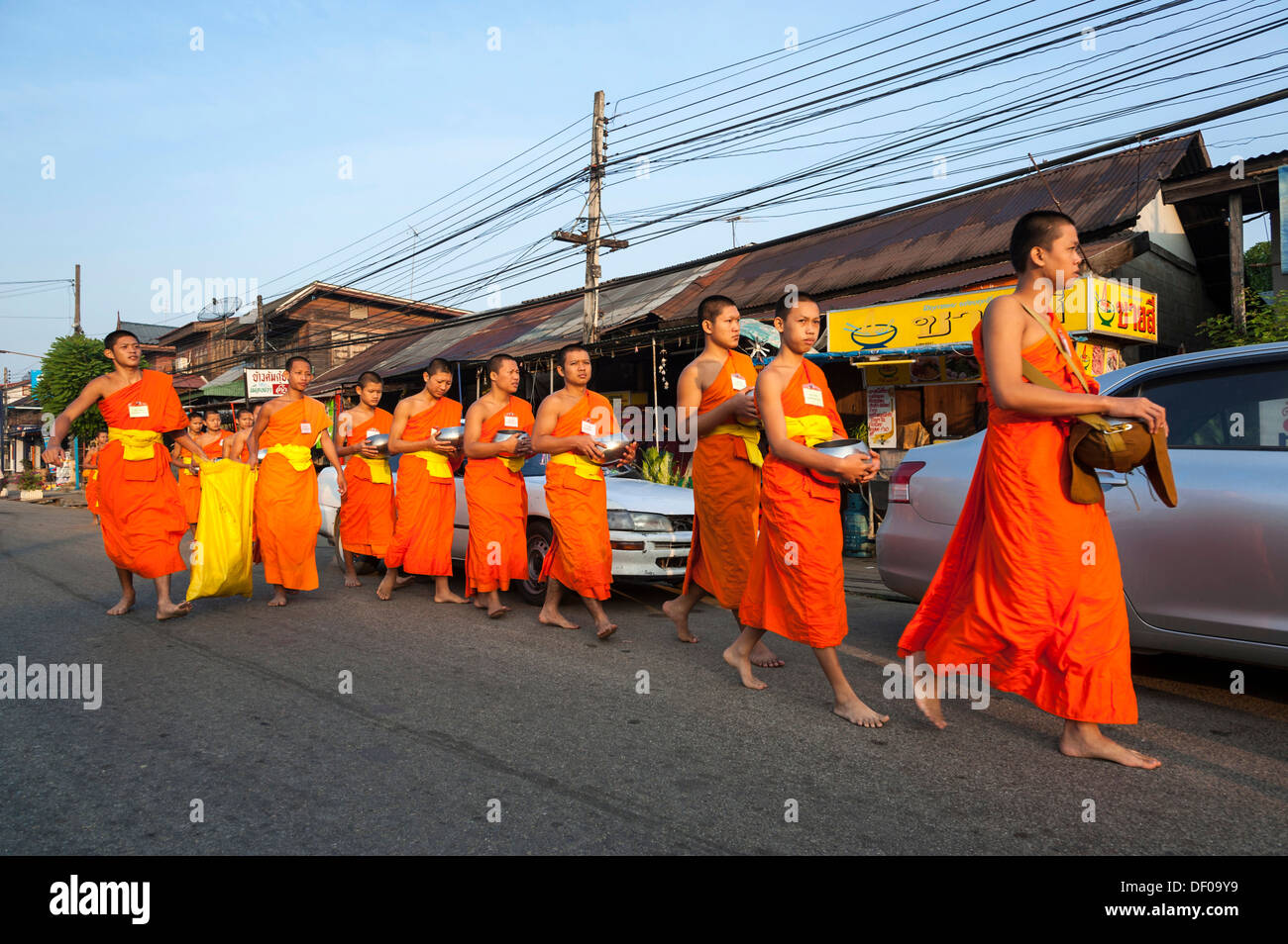 Morning alms round, young Buddhist monks from a monastery school ...