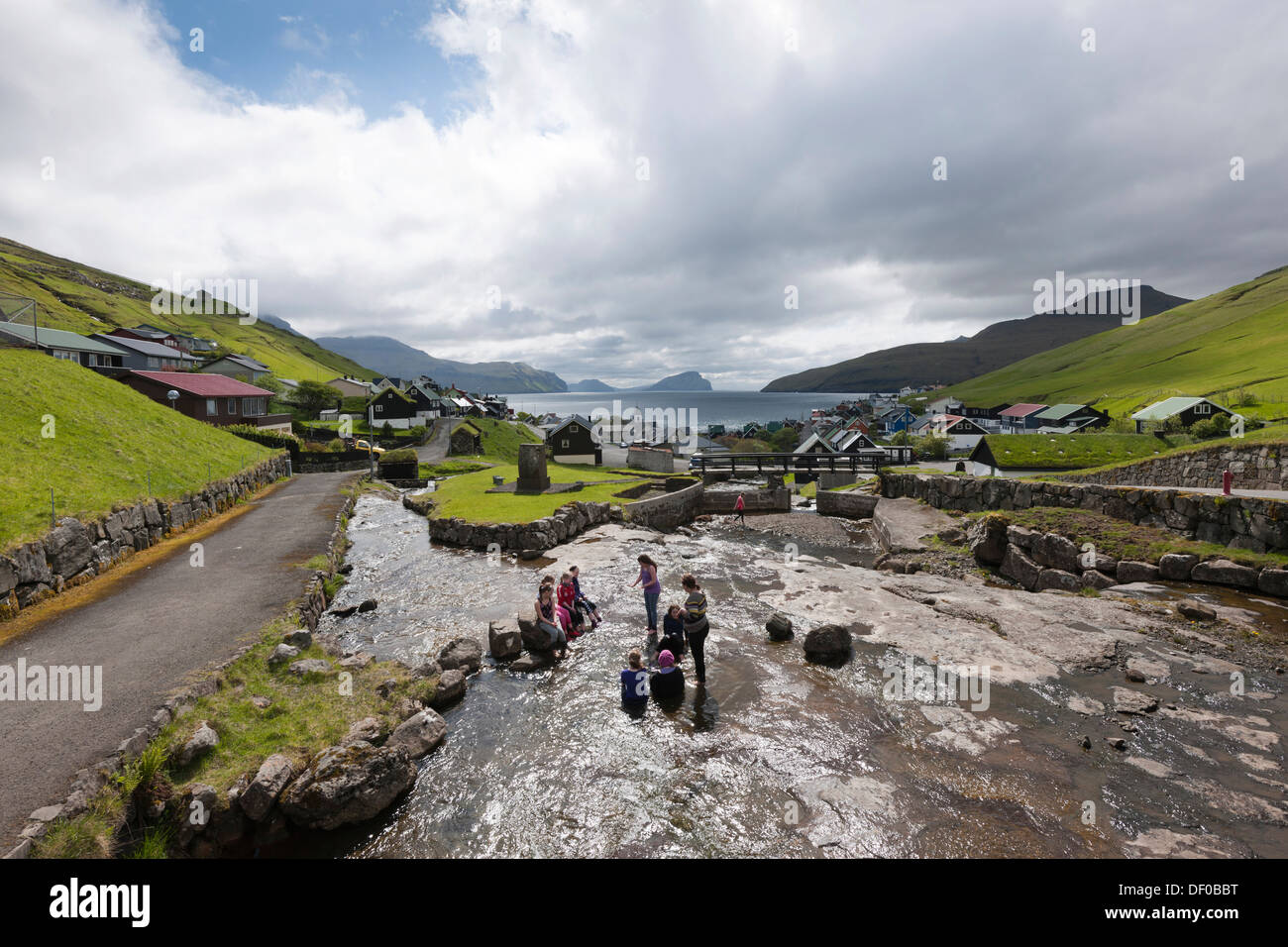 School children taking a break in a cold stream, village of Kvívík ...