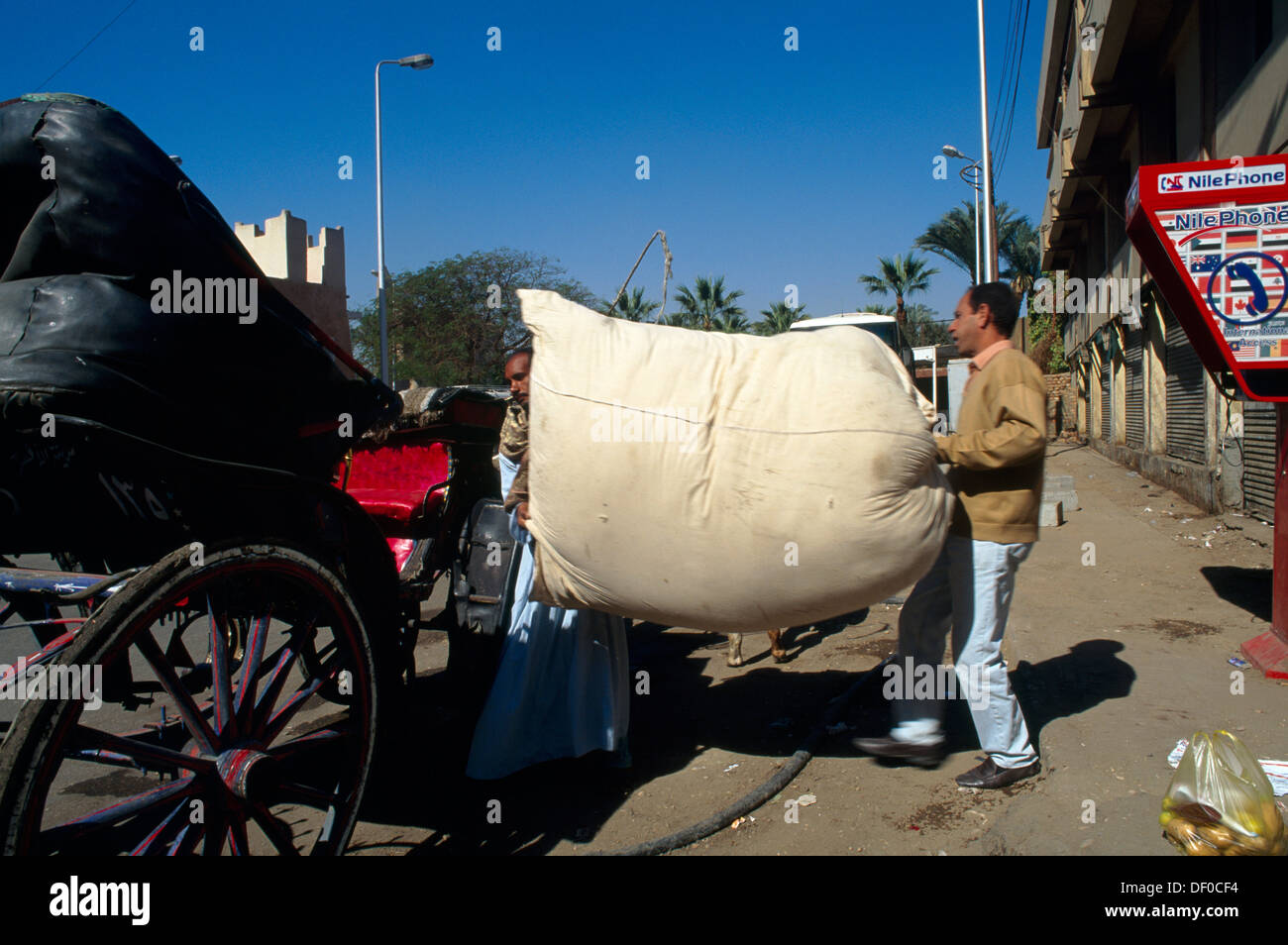 Luxor Egypt Men Loading Sack Into Calache In Bazaar Stock Photo - Alamy