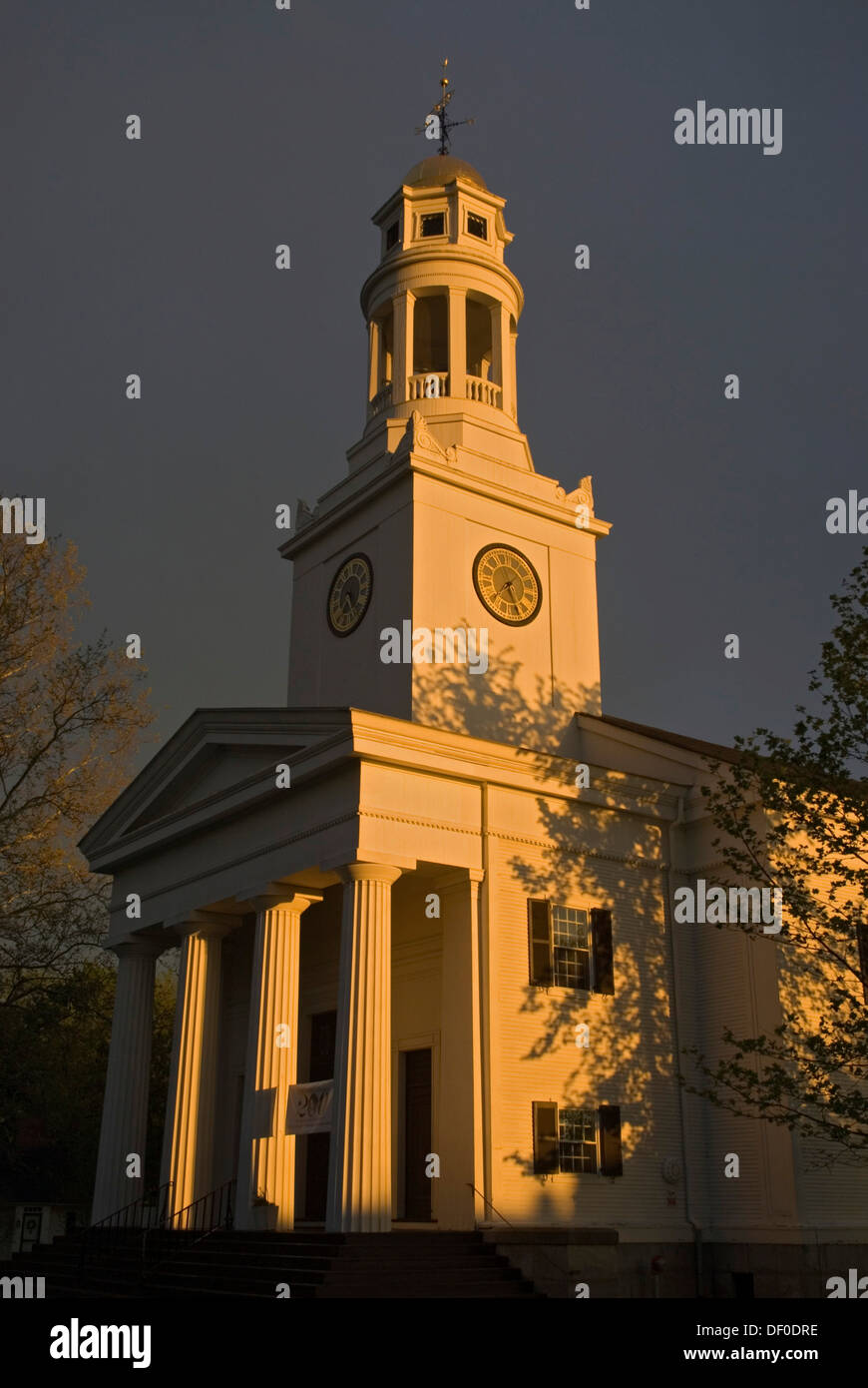 First Parish Church in front of dark thunderstorm clouds, illuminated ...