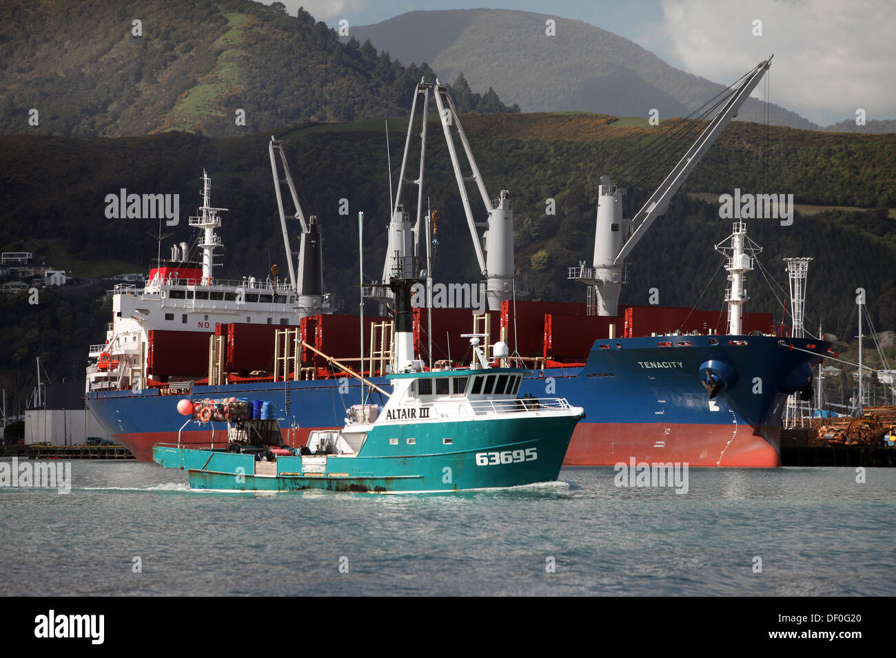 Altair 3 trawler passing cargo ship alongside Port Nelson, Nelson, New ...