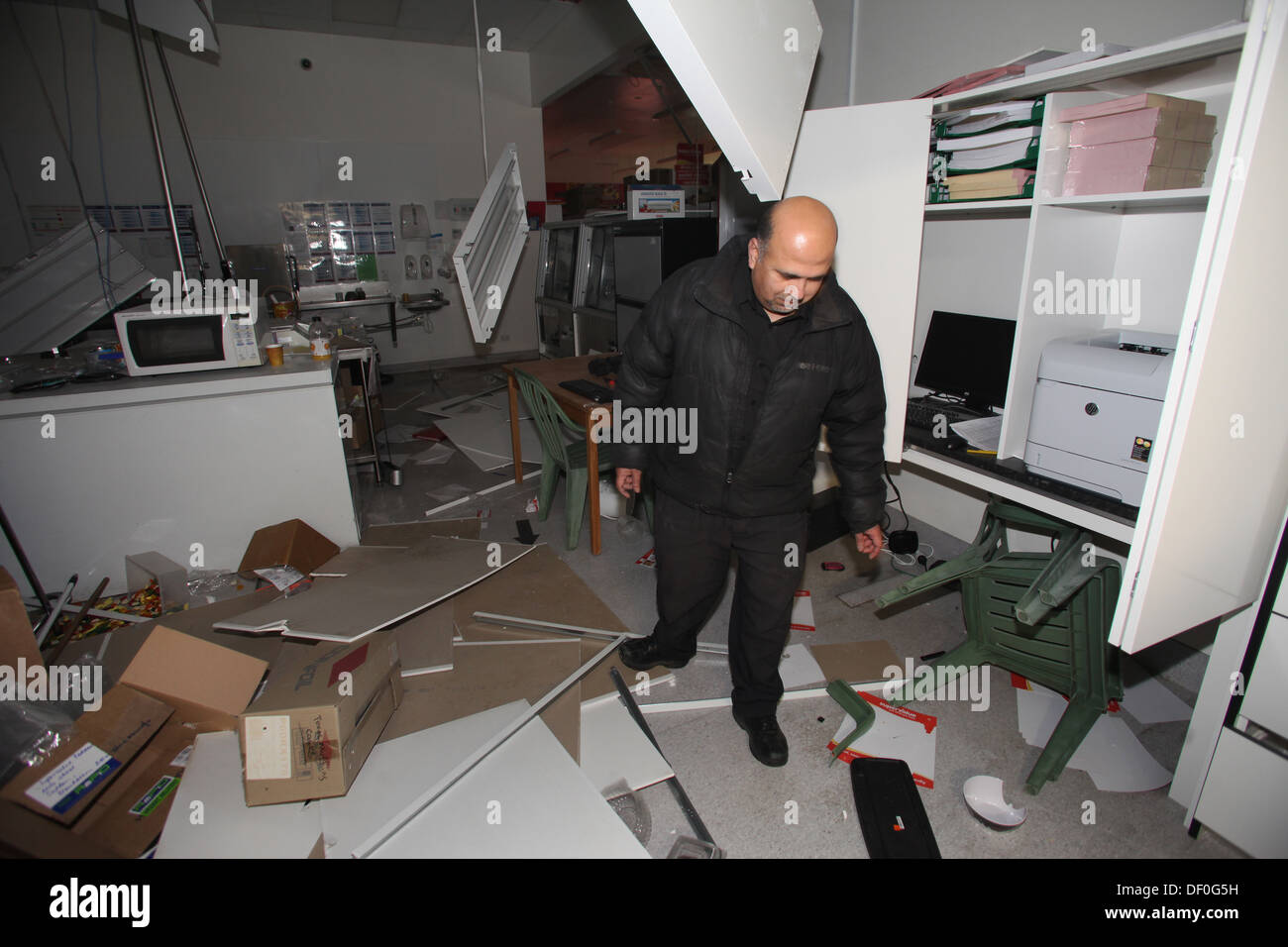 Shop owner inside a supermarket ruined after a severe earthquake struck ...