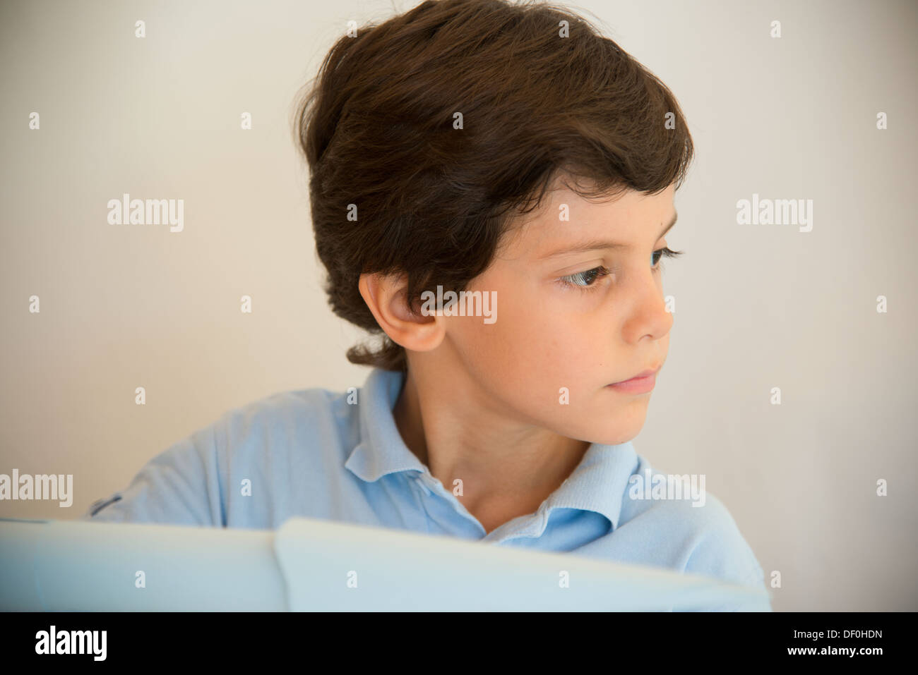 A preschool boy flying paper aircraft in light blue Stock Photo - Alamy