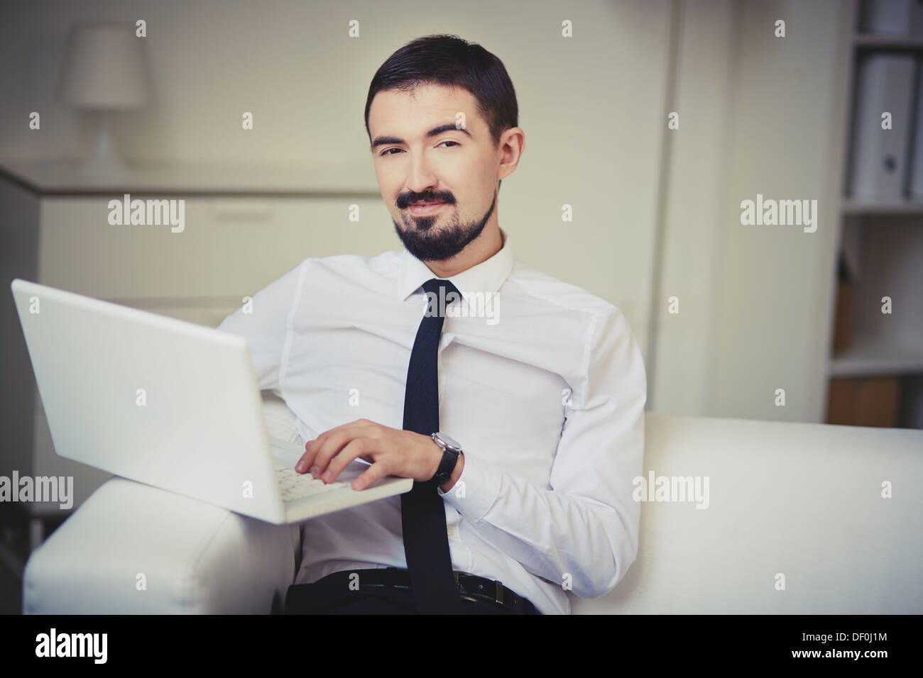 Portrait of posh guy with laptop looking at camera Stock Photo - Alamy