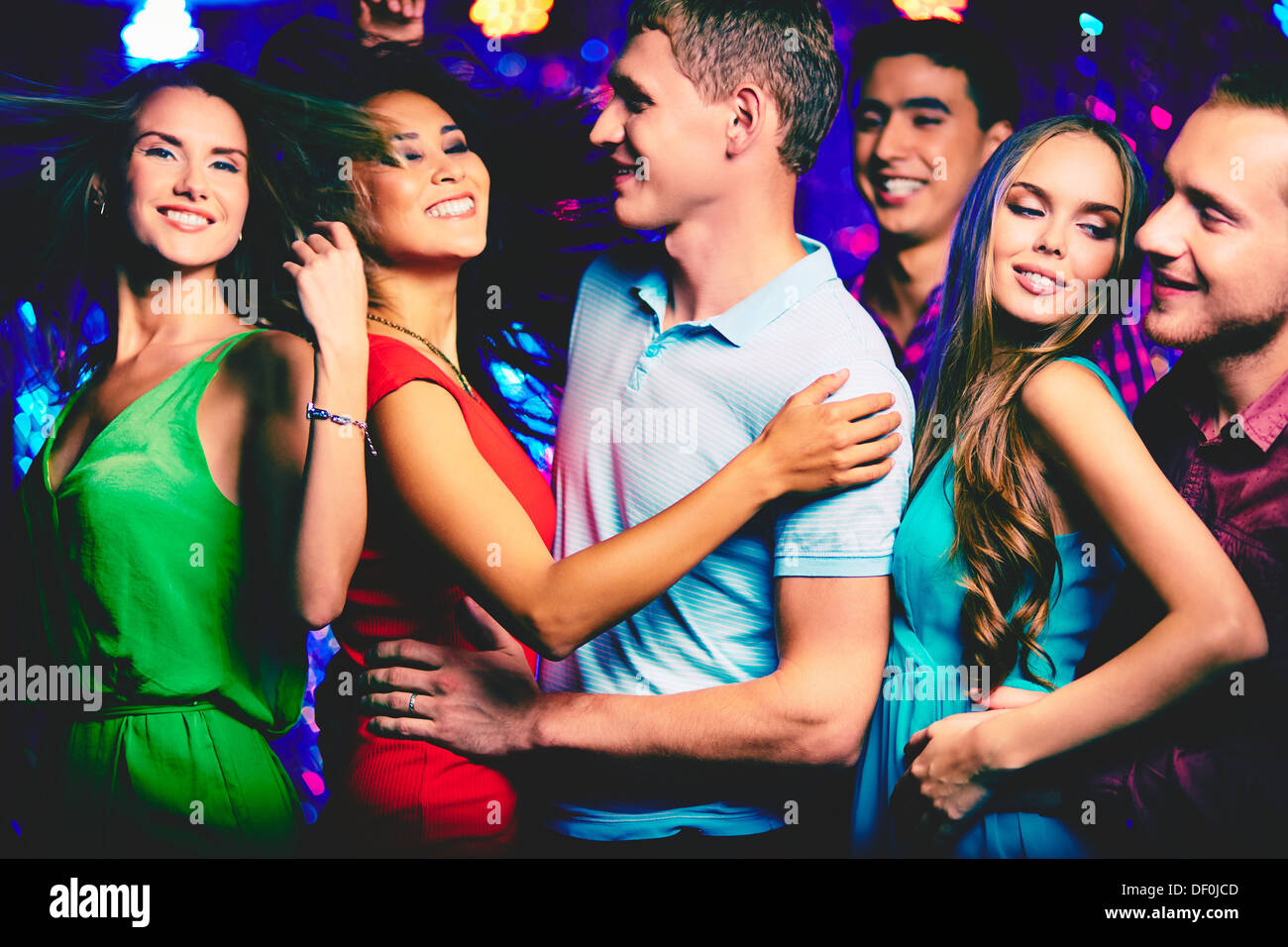 Happy young friends dancing at disco Stock Photo - Alamy