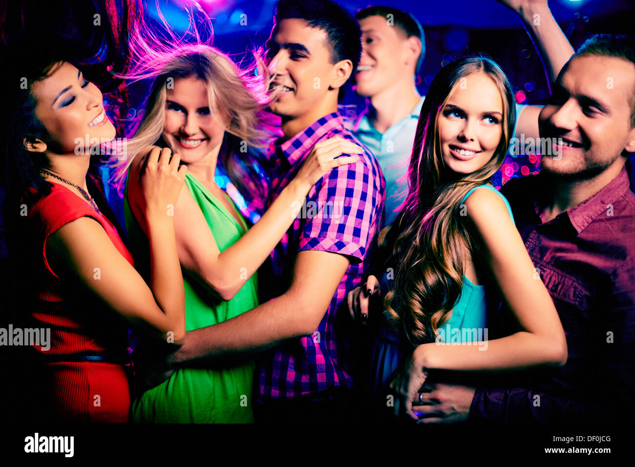 Happy young friends dancing at disco Stock Photo - Alamy