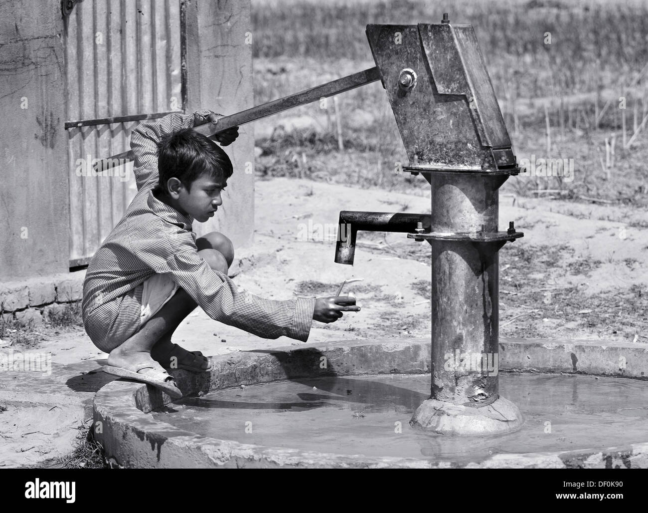 Boy pumping well water hi-res stock photography and images - Alamy