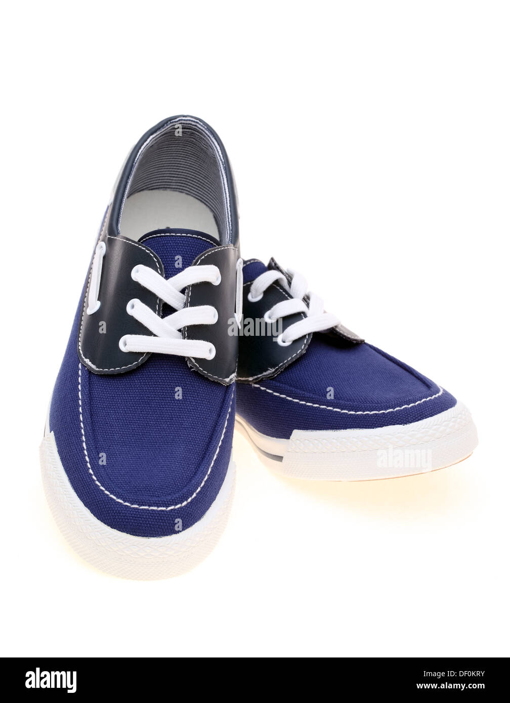 pair of walking blue sneakers on white background Stock Photo - Alamy