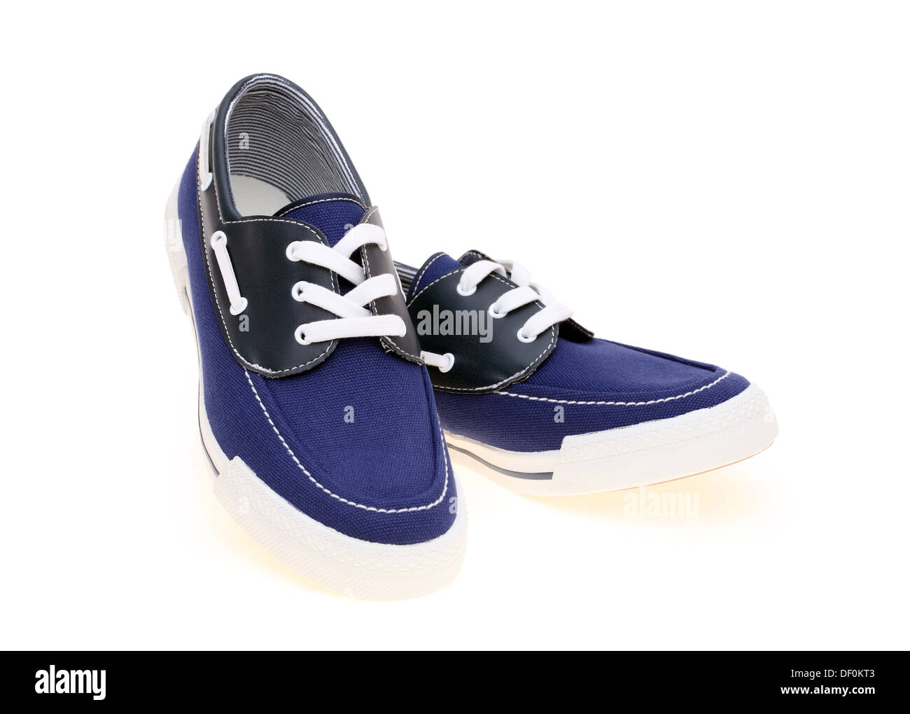 pair of walking blue sneakers on white background Stock Photo - Alamy
