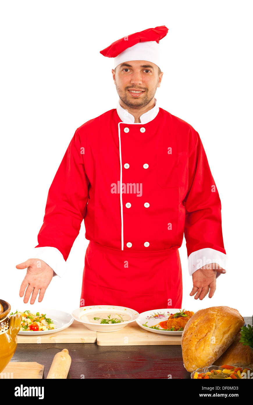 Happy chef showing plates with food in kitchen against white background ...
