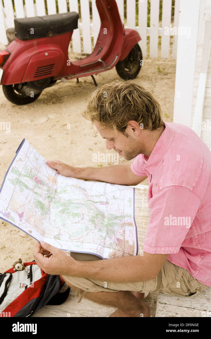Man looking up in a map Stock Photo - Alamy