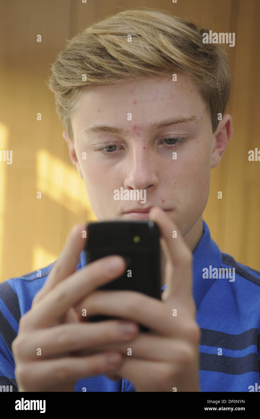 Teenage Boy Using A Mobile Phone Stock Photo - Alamy