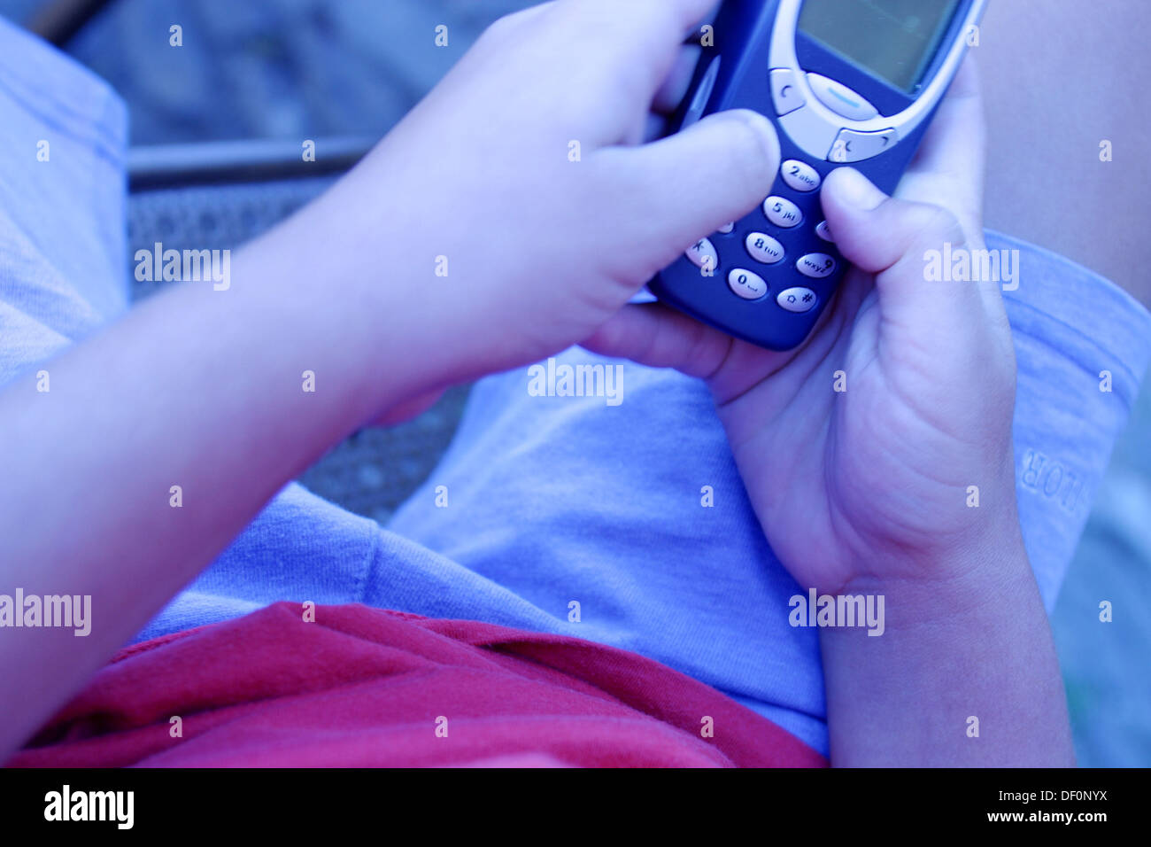 Boy using cell phone Stock Photo - Alamy