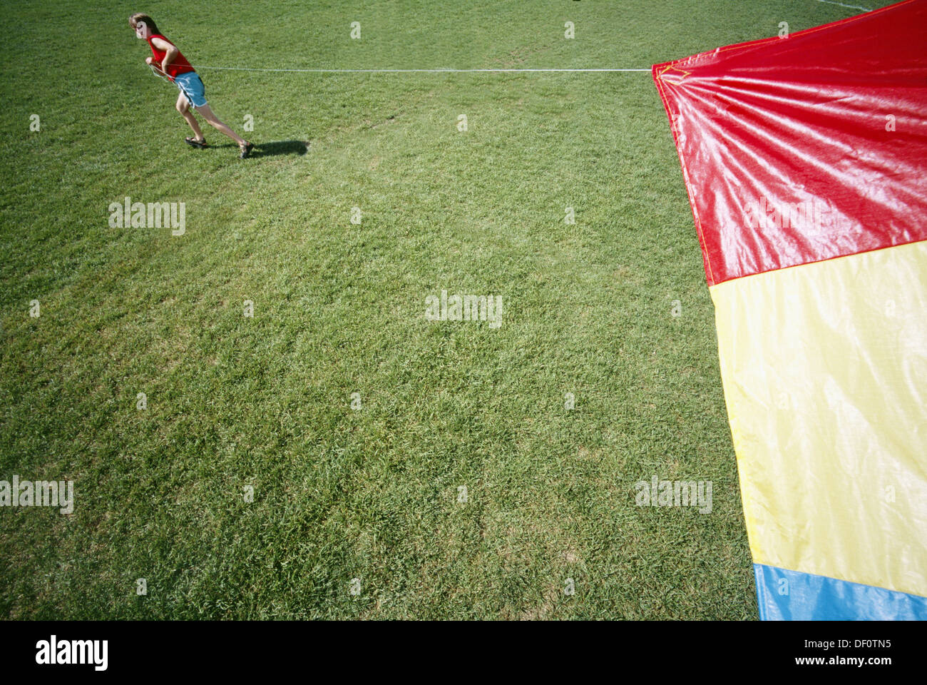Child flying kite pulling hi-res stock photography and images - Alamy