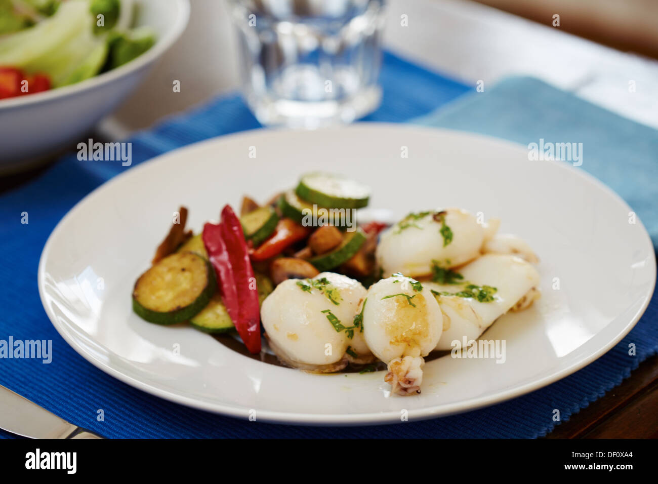 Grilled cuttlefish and vegetables in a table Stock Photo - Alamy
