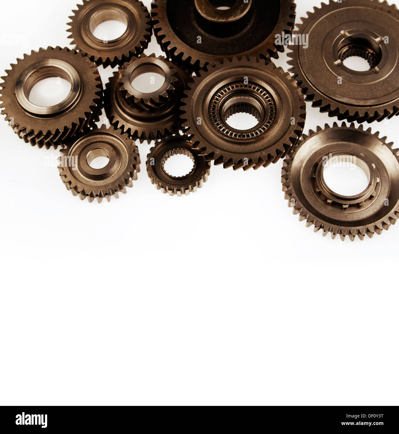 Metal cog wheels bonding together on plain background Stock Photo - Alamy