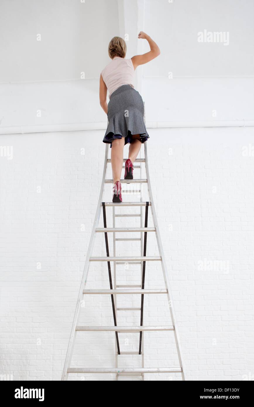 Woman Climbing Ladder Interior High Resolution Stock Photography and ...
