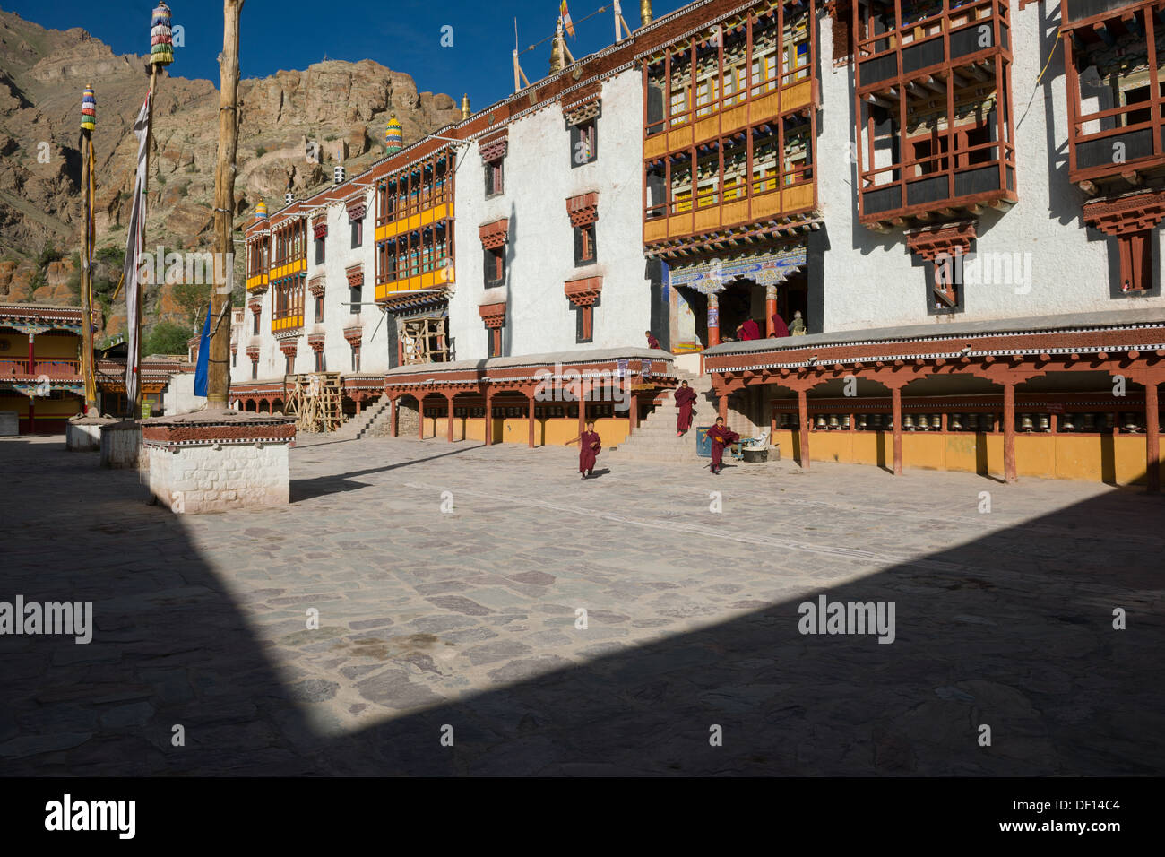 Novice monks running out of the prayer hall into the courtyard of Hemis ...