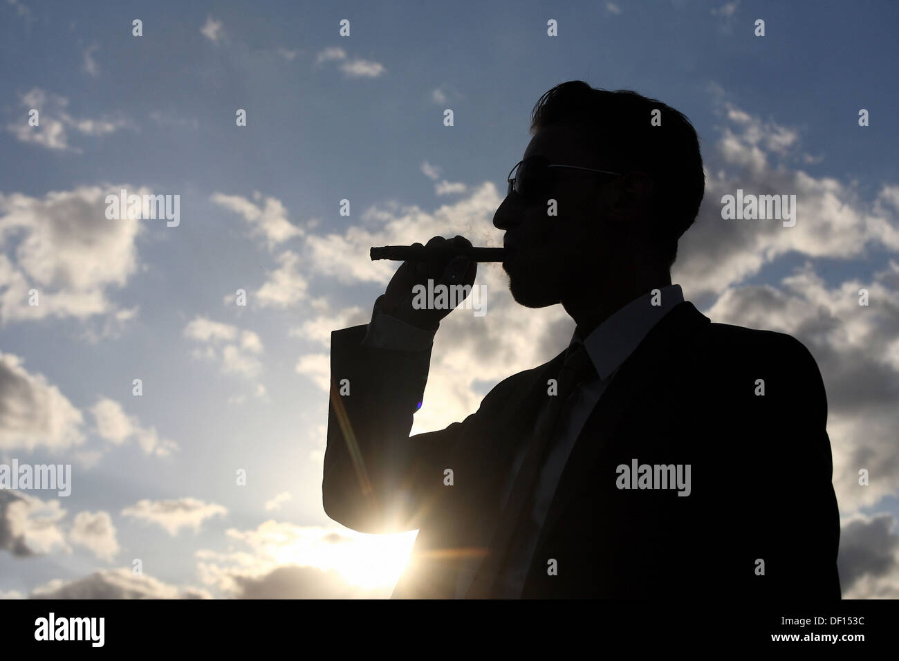 Berlin, Germany, man smoking a cigar in the back light Stock Photo - Alamy
