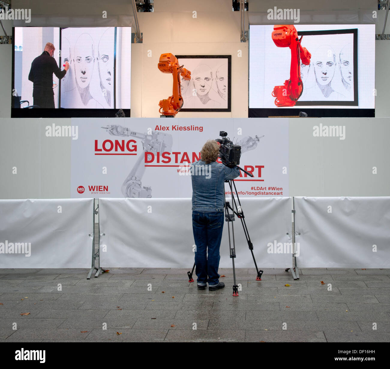 A remote controlled robot (C) draws a part of the artwork 'Long ...
