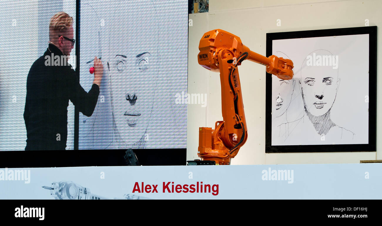 A remote controlled robot (R) draws a part of the artwork 'Long ...