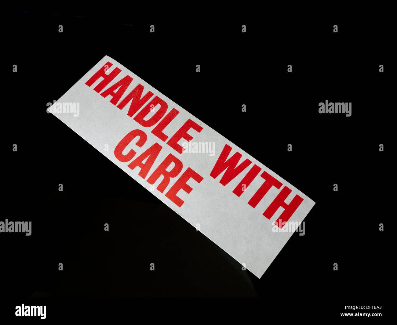 Handle with care sign on black background Stock Photo - Alamy