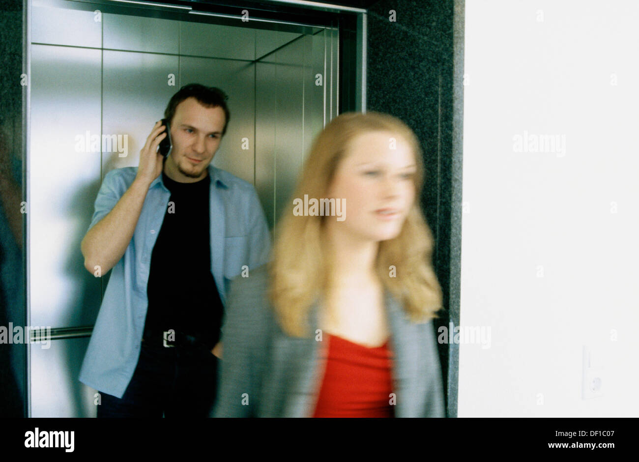 Woman exit elevator hi-res stock photography and images - Alamy