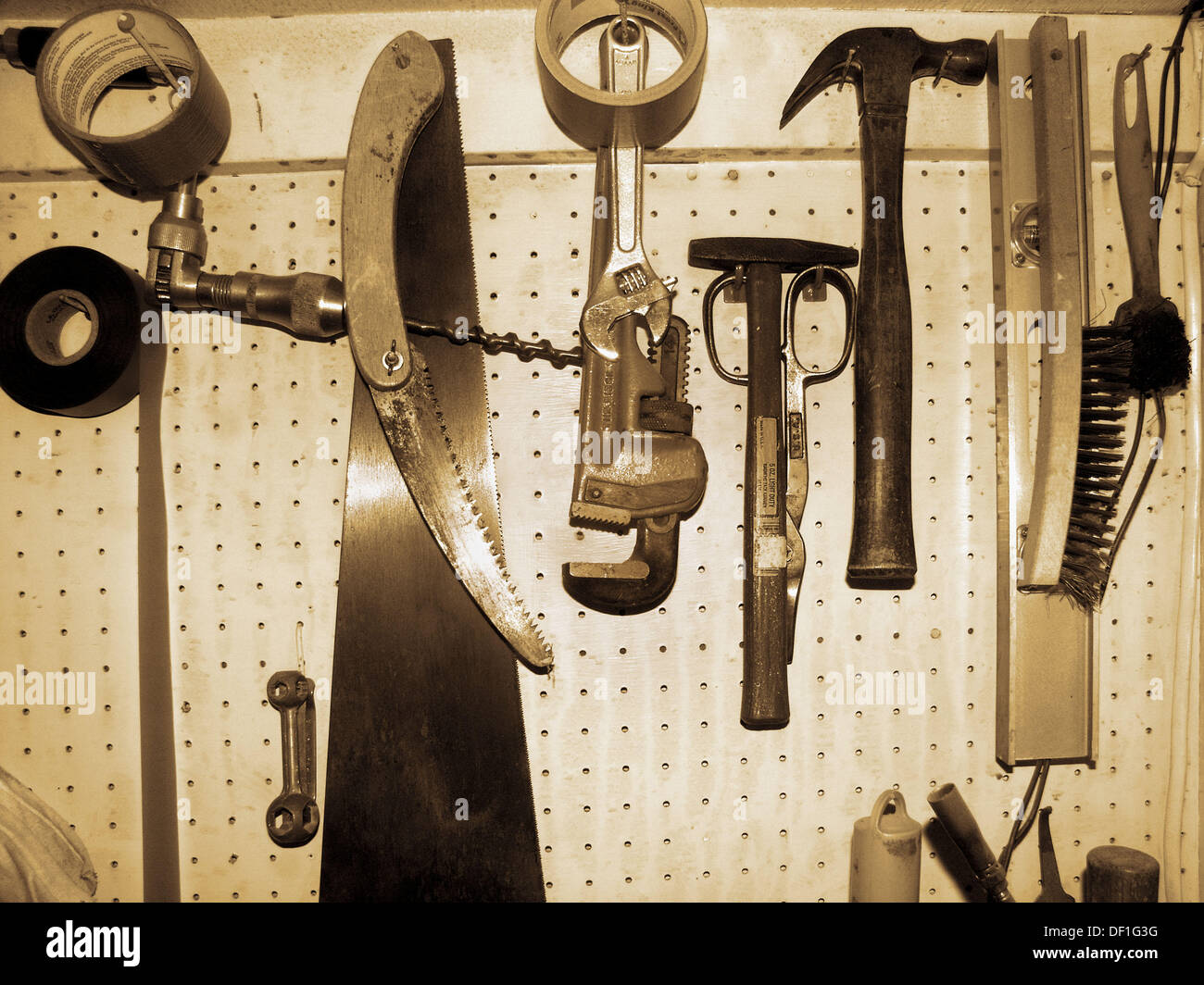 Collection of hand tools hanging on pegboard Stock Photo - Alamy