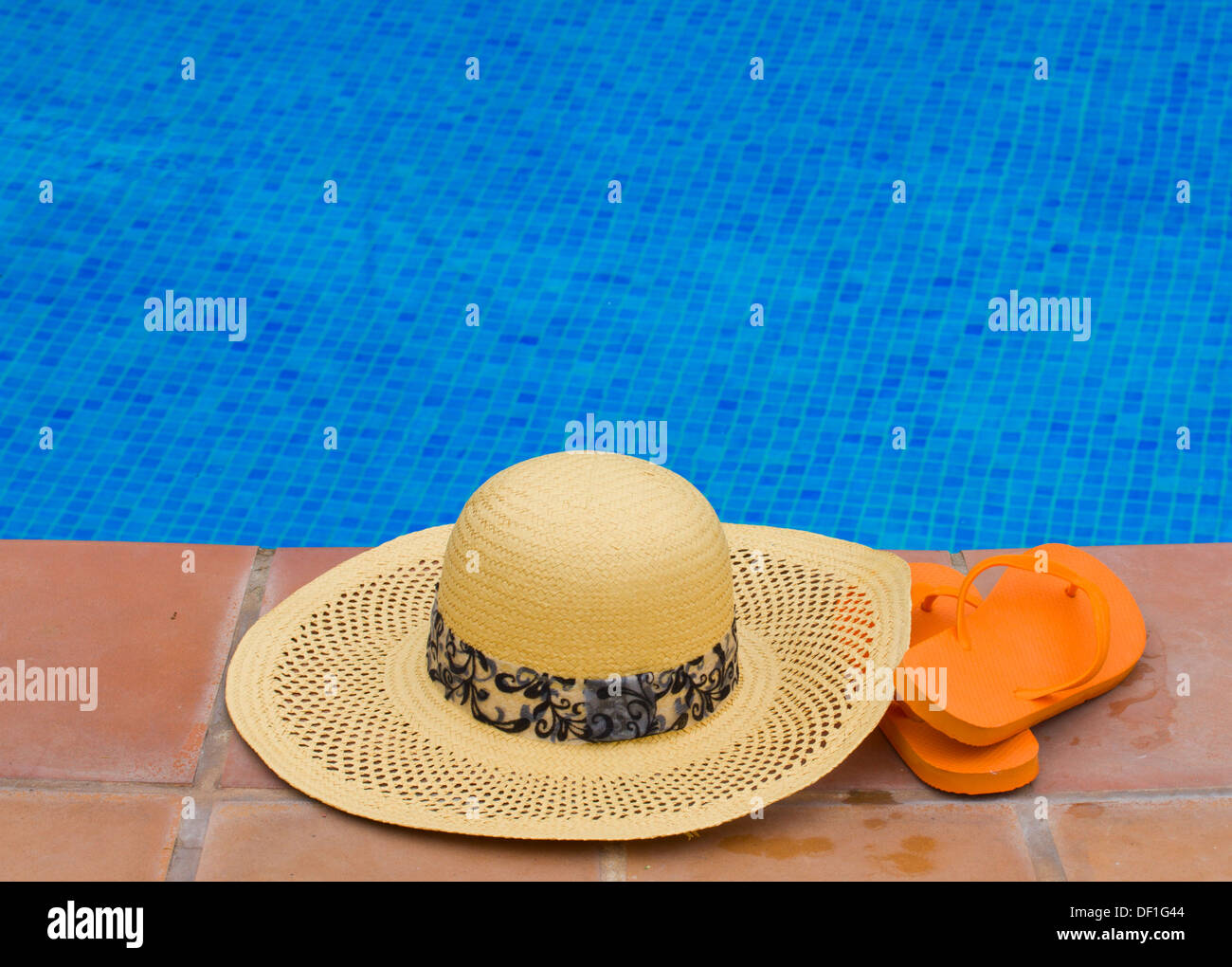 straw hat and sandals by pool side Stock Photo - Alamy