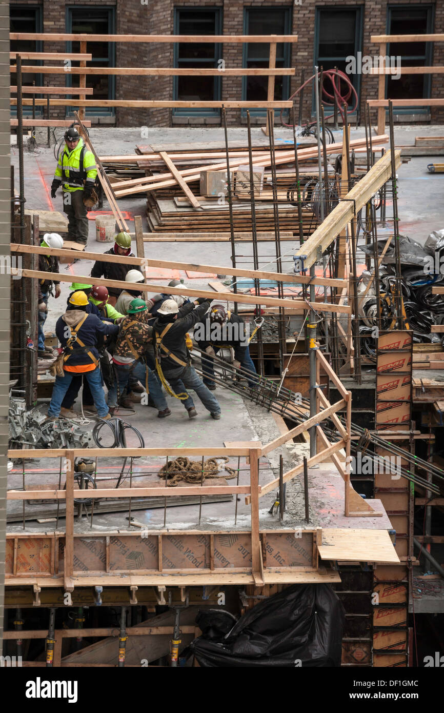 High-rise Building Construction Site with Tradesmen, NYC Stock Photo ...
