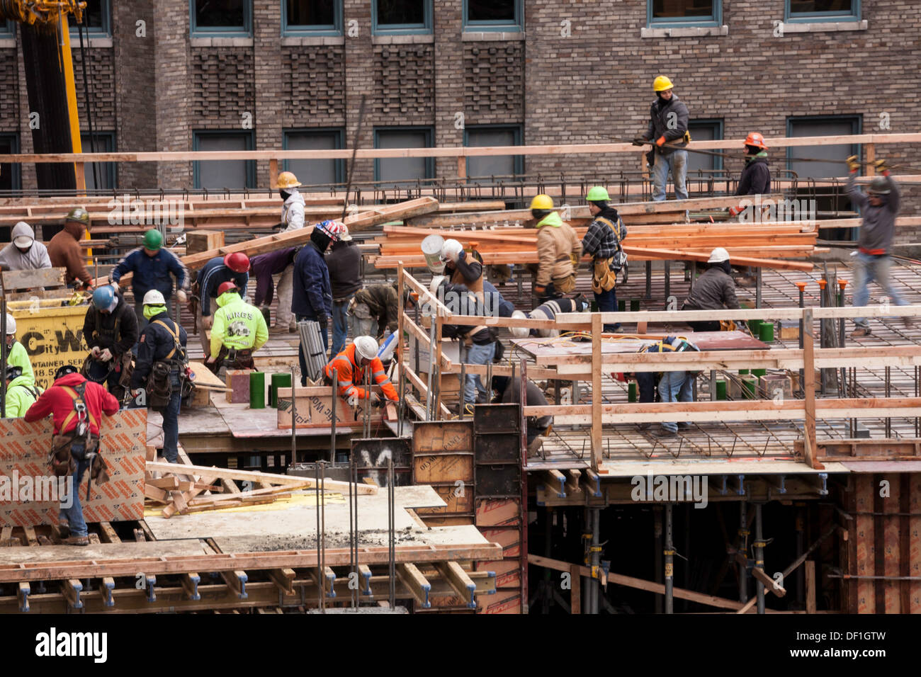 High-rise Building Construction Site with Tradesmen Stock Photo - Alamy