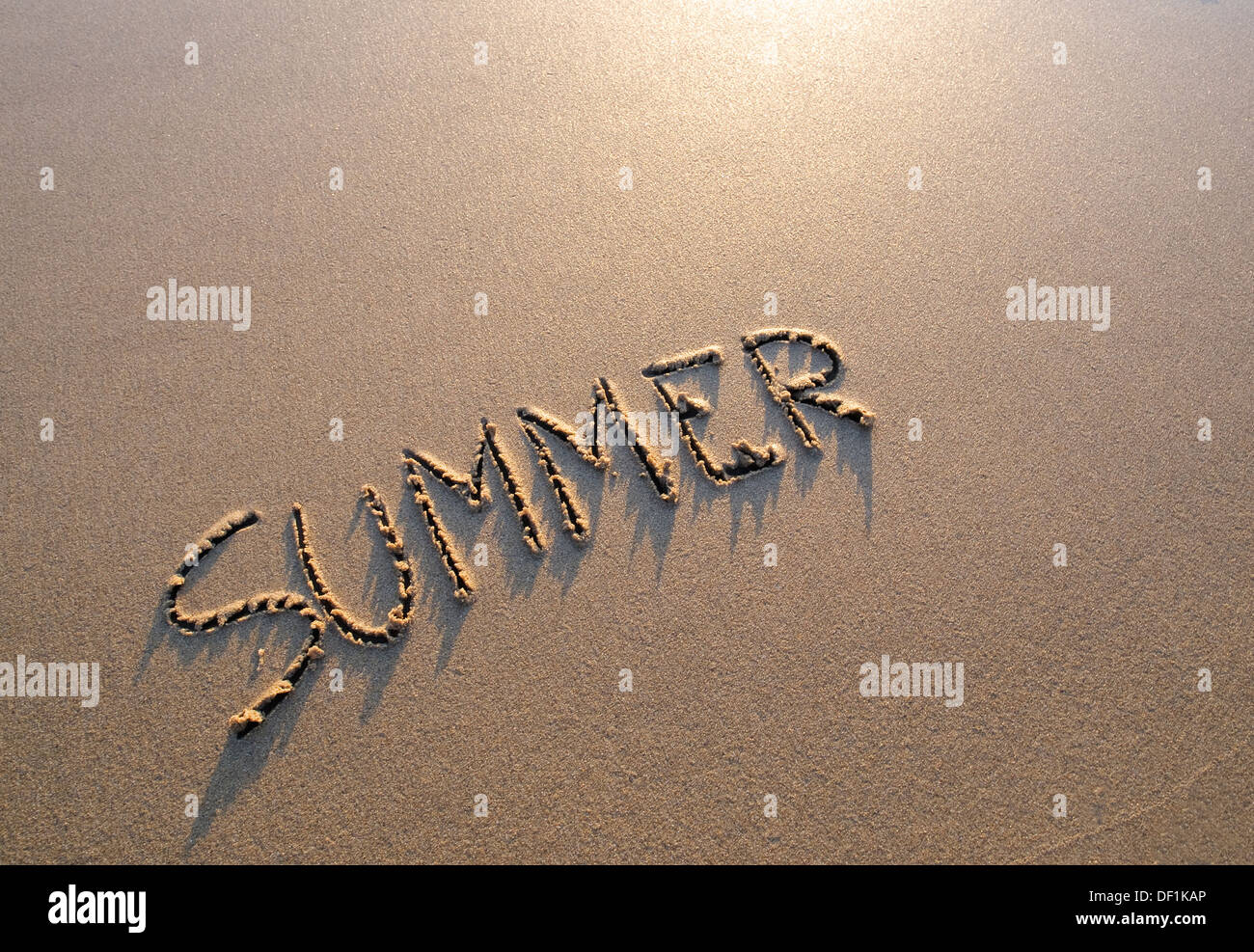 Word summer written in the sand. The text is written in the sand of a ...