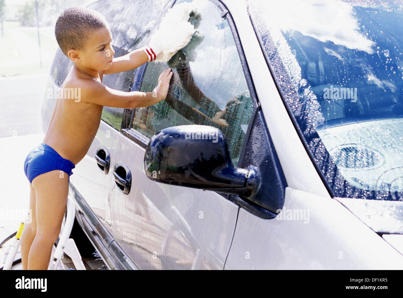 Male children washing car hi-res stock photography and images - Alamy