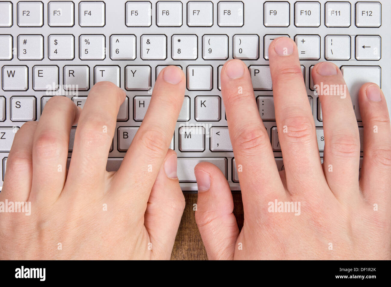 Hands typing on a computer keyboard. View from above Stock Photo - Alamy