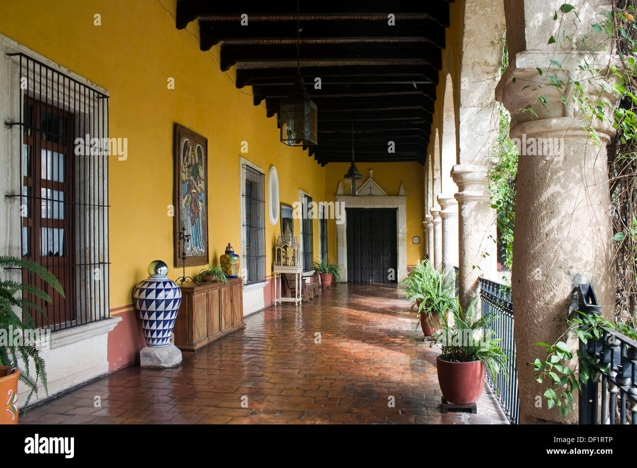 Portico, loggia or colonnade with wood beamed ceiling, terracotta tile ...