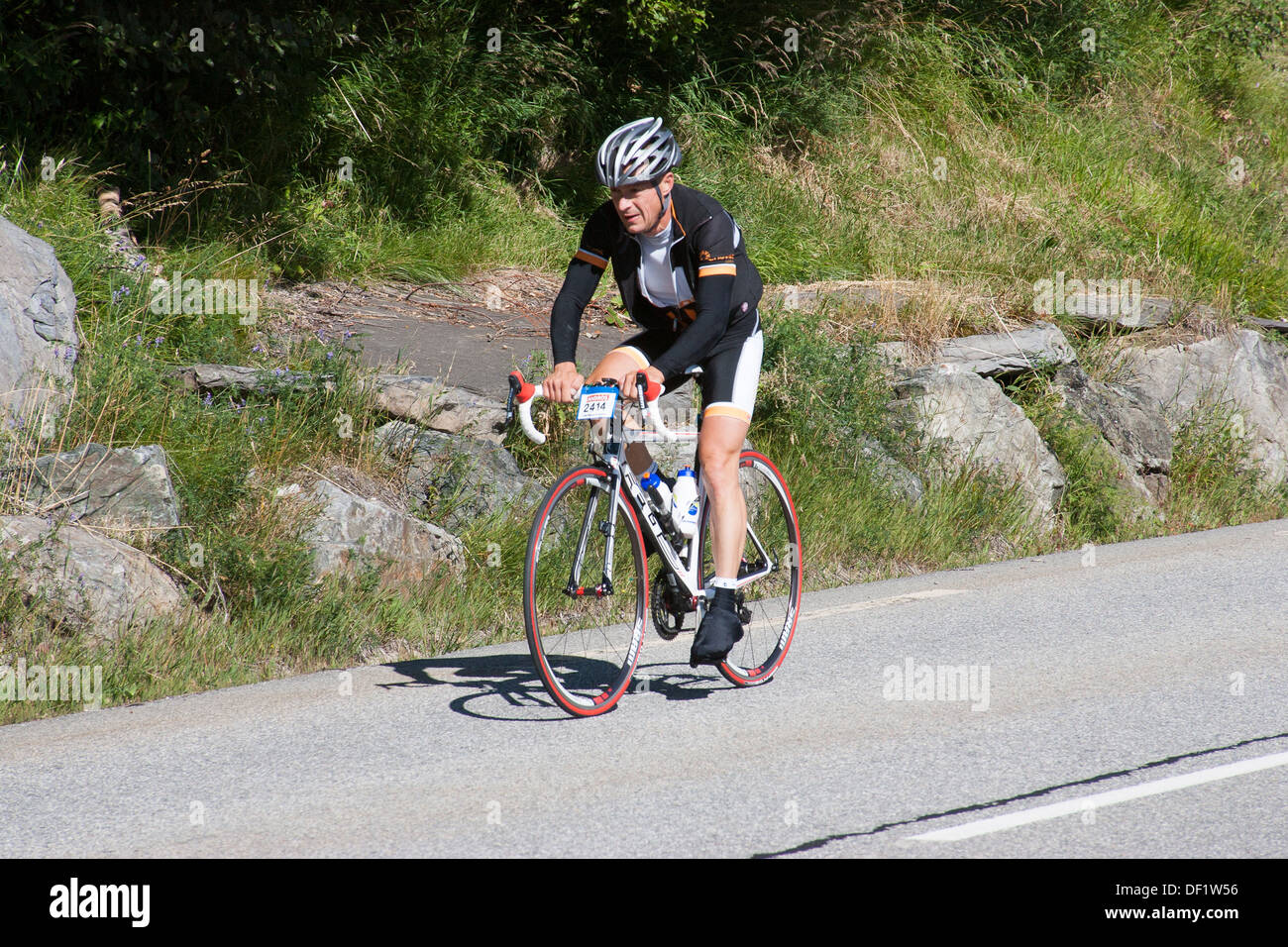 cyclist riding determined rock grass wheels pedal Stock Photo - Alamy