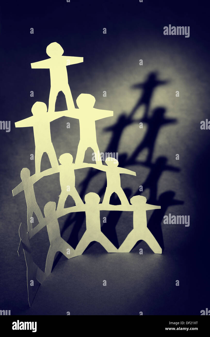 Human team pyramid and shadow Stock Photo - Alamy