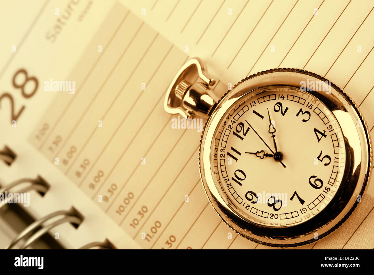 Pocket watch on diary page Stock Photo - Alamy