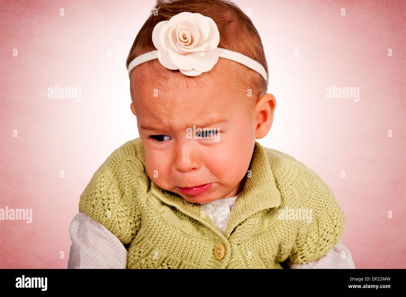 Little sad baby on the pink background Stock Photo - Alamy