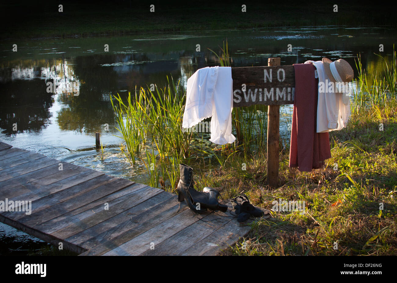 NO Swimming sign by a pond with vintage clothes hanging from sign Stock ...