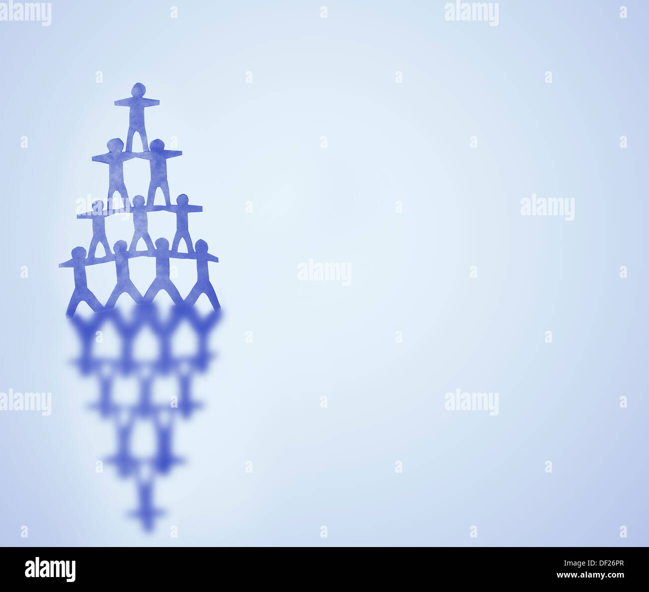 Human team pyramid on blue background Stock Photo - Alamy