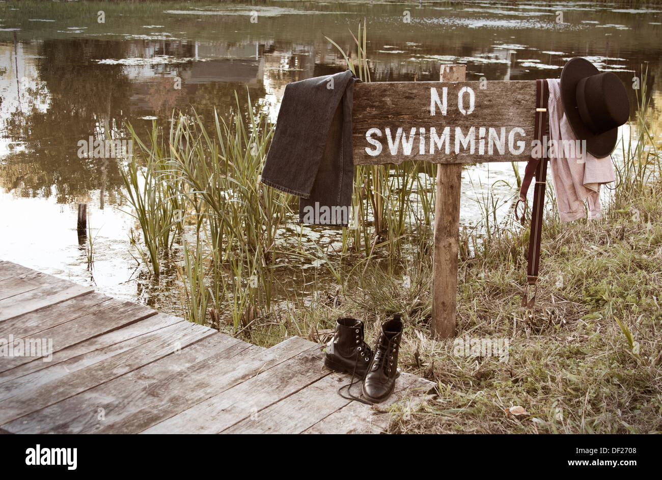 NO Swimming sign by a pond with vintage clothes hanging from sign Stock ...