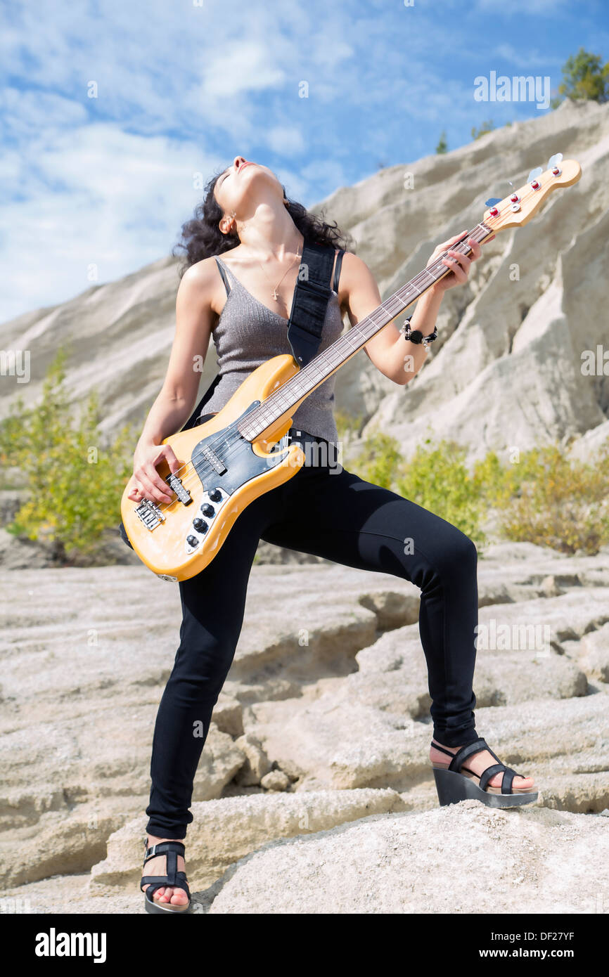 Young woman playing bass guitar hi-res stock photography and images - Alamy