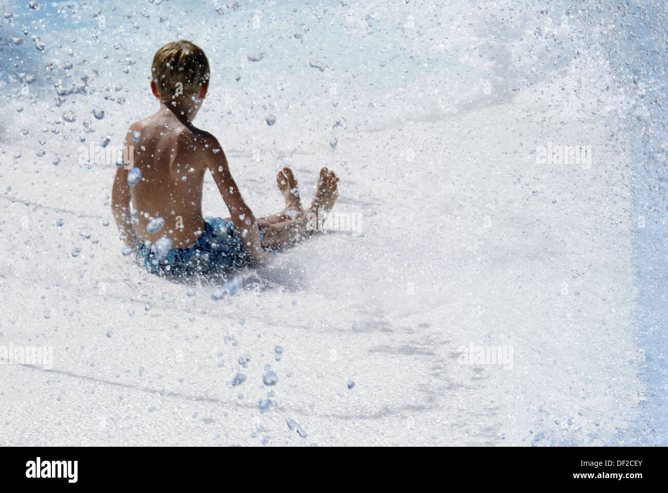 Boy sliding down a water slide hi-res stock photography and images - Alamy