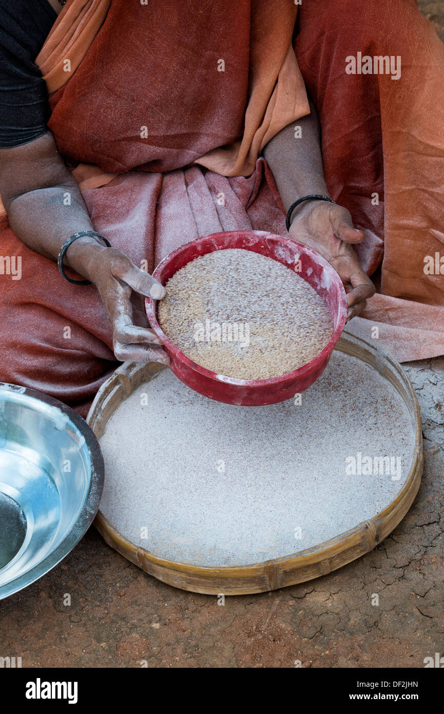Rural Indian village woman sifting Finger Millet flour / Ragi flour ...